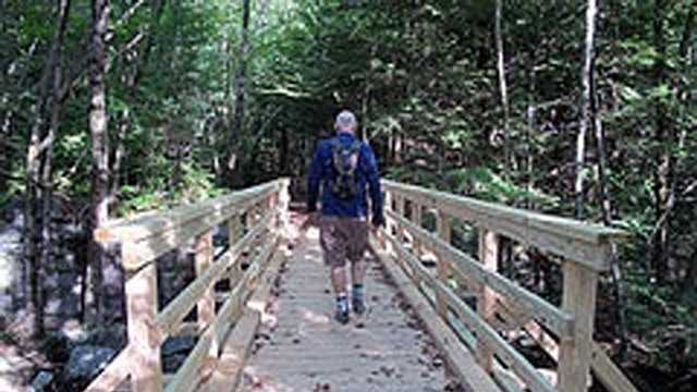 More than 100 acres conserved; New rail trail bridge built