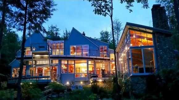 Mansion Monday: Lakeside home has glass walls, 2-story waterfall ...