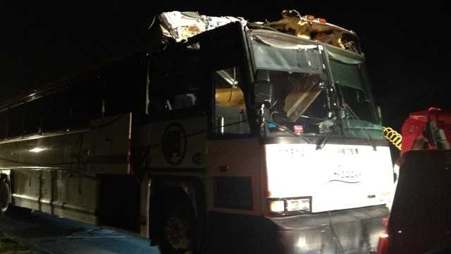 Students injured when charter bus strikes school building overhang