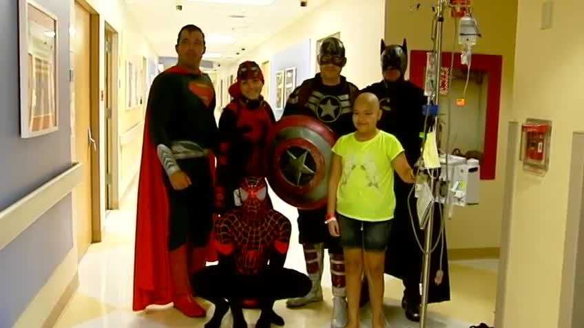 Photos: Man plays superhero for sick kids