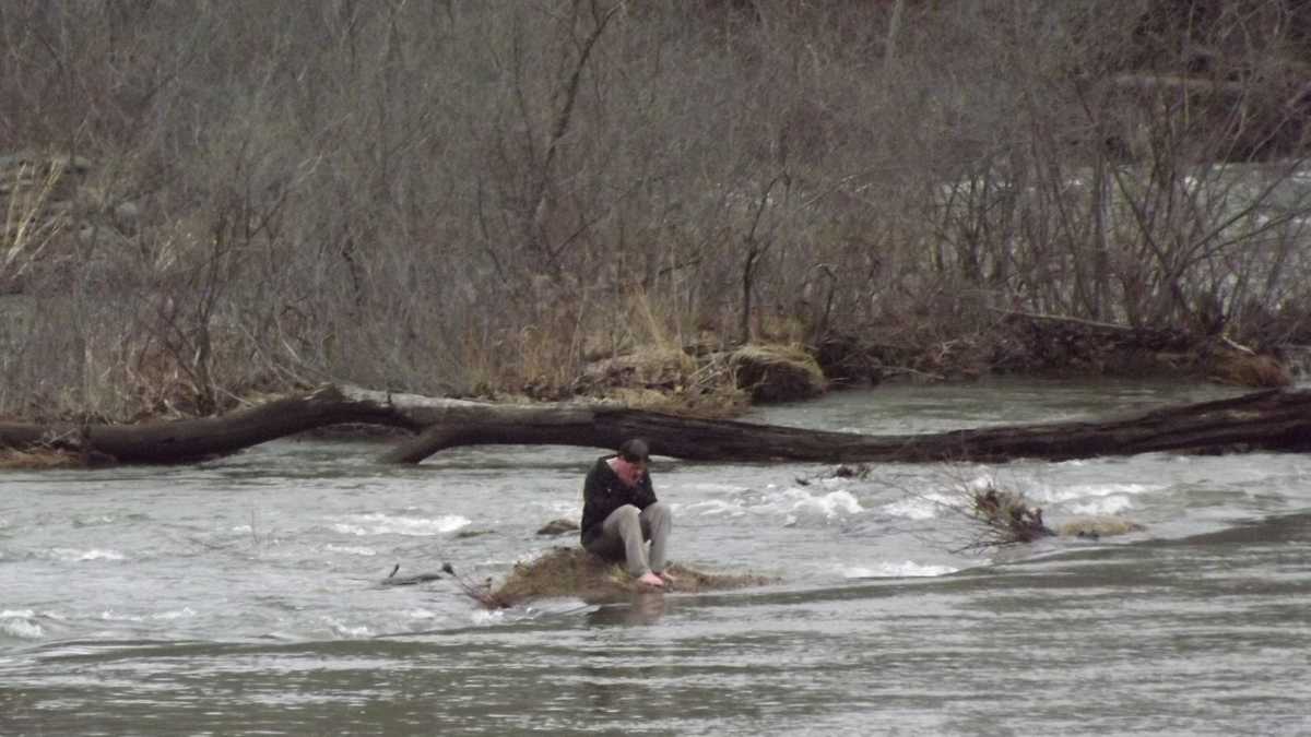 Photos: Man stranded on rock in river