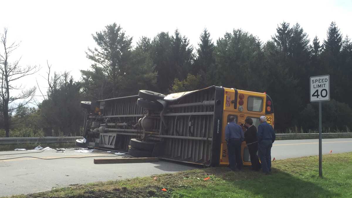 Photos: Crash causes school bus to overturn