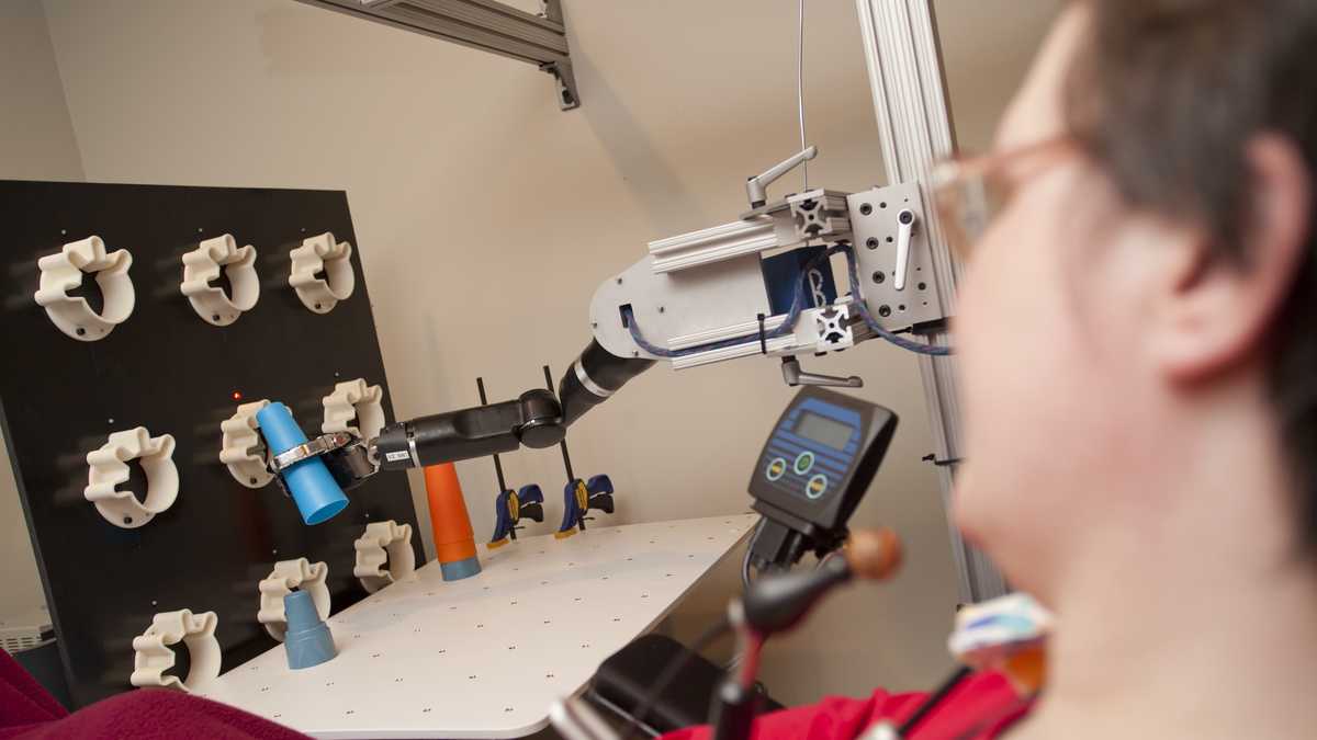 Quadriplegic feeds herself with mind-controlled robot arm