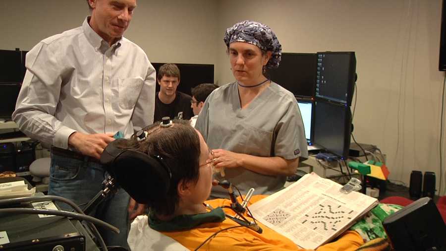 Quadriplegic feeds herself with mind-controlled robot arm