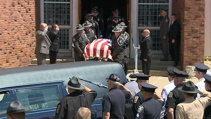 Thousands of police join officer's funeral procession