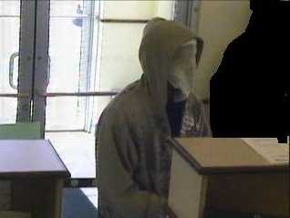 Photos: Surveillance images show bank robber jumping over counter