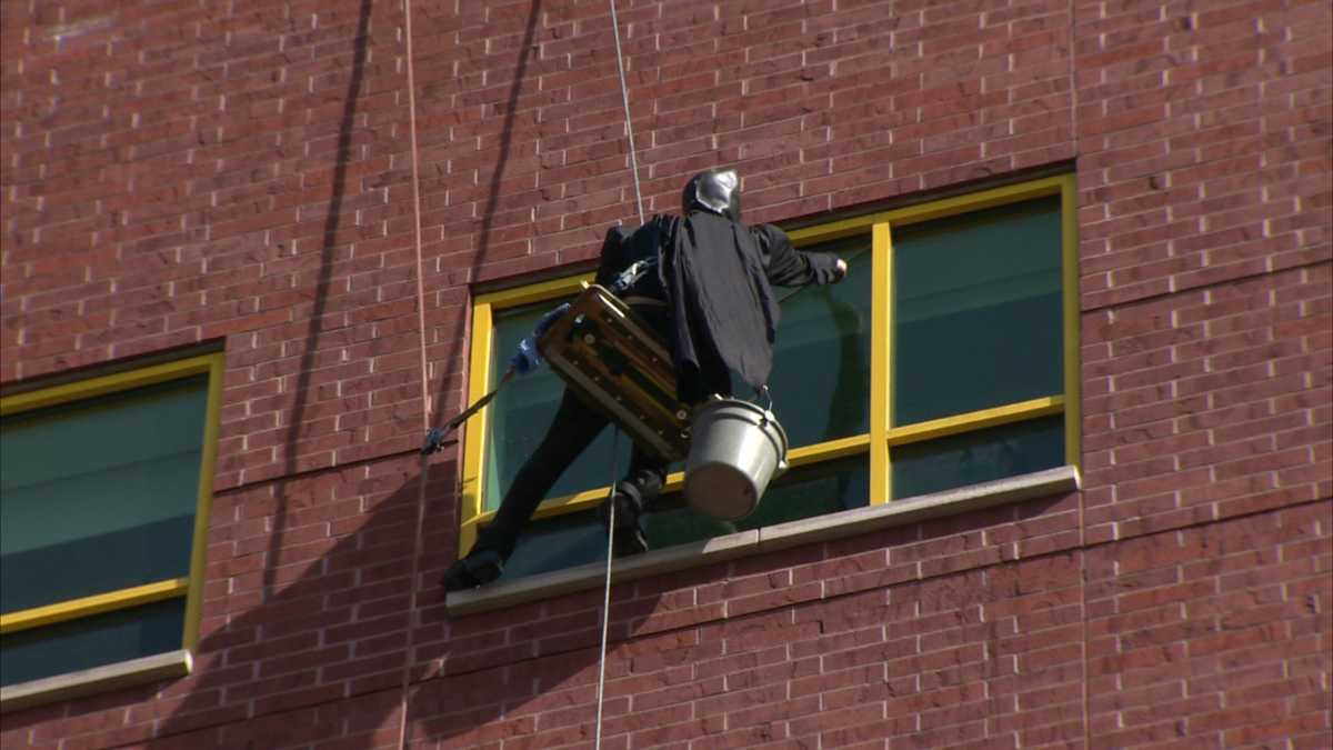 Superhero window-washers thrill young hospital patients