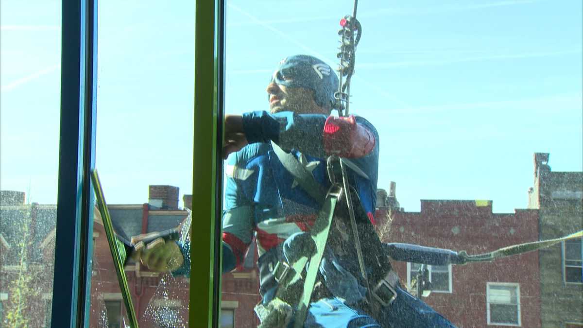 Superhero window-washers thrill young hospital patients