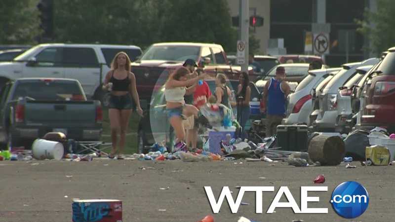 Video: Young woman kicks trash around parking lot during Luke Bryan ...