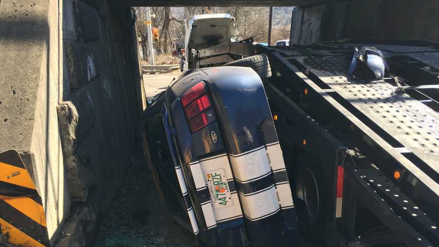 2 vehicles damaged after car carrier gets stuck in tunnel