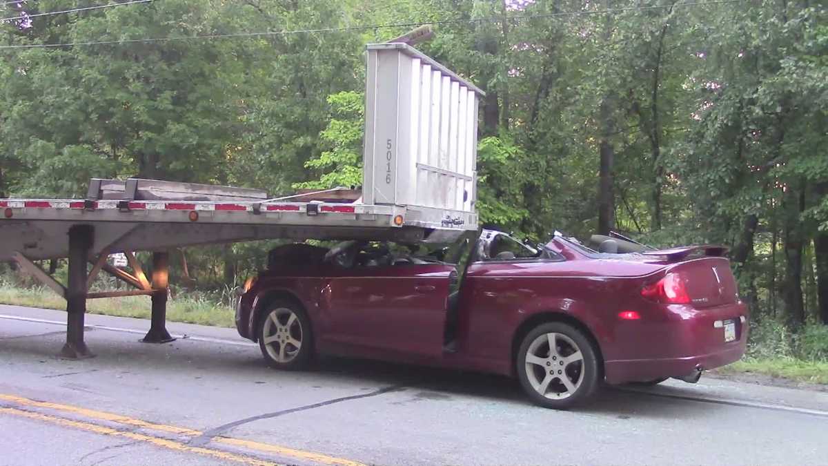 Car slams into breakaway flatbed trailer, leaving driver trapped underneath