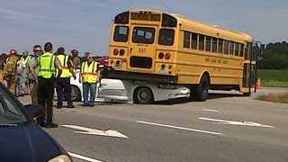 Teen's car wedged under NC school bus, bus driver charged