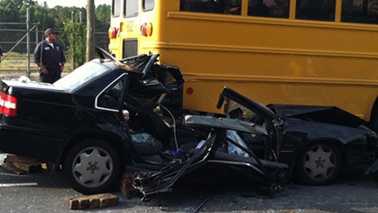 2 injured after car wedges under Charlotte school bus