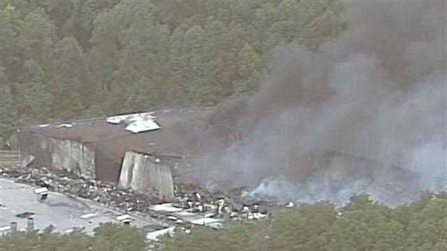 Smoldering flames reignite at textile plant