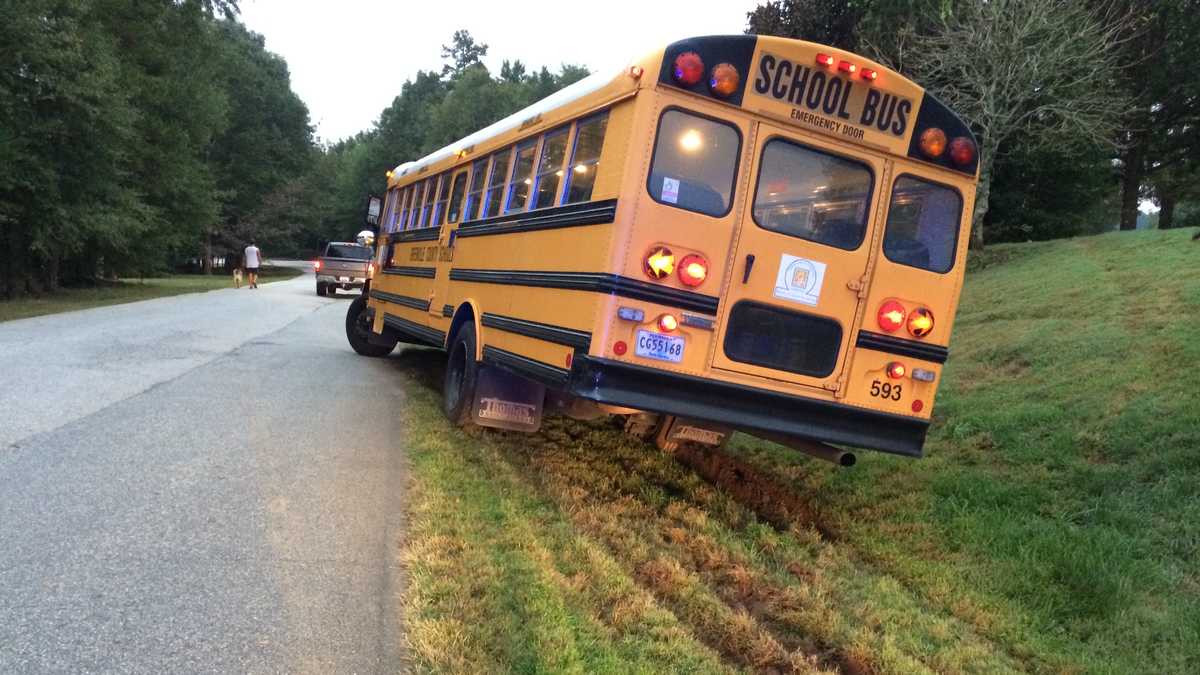 School bus with students on board gets stuck in ditch