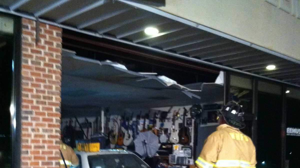 Pictures: Car crashes into building when driver reaches to get phone ...