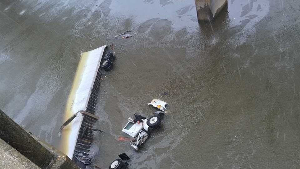 Driver to face charges after tractor-trailer goes off bridge, troopers say