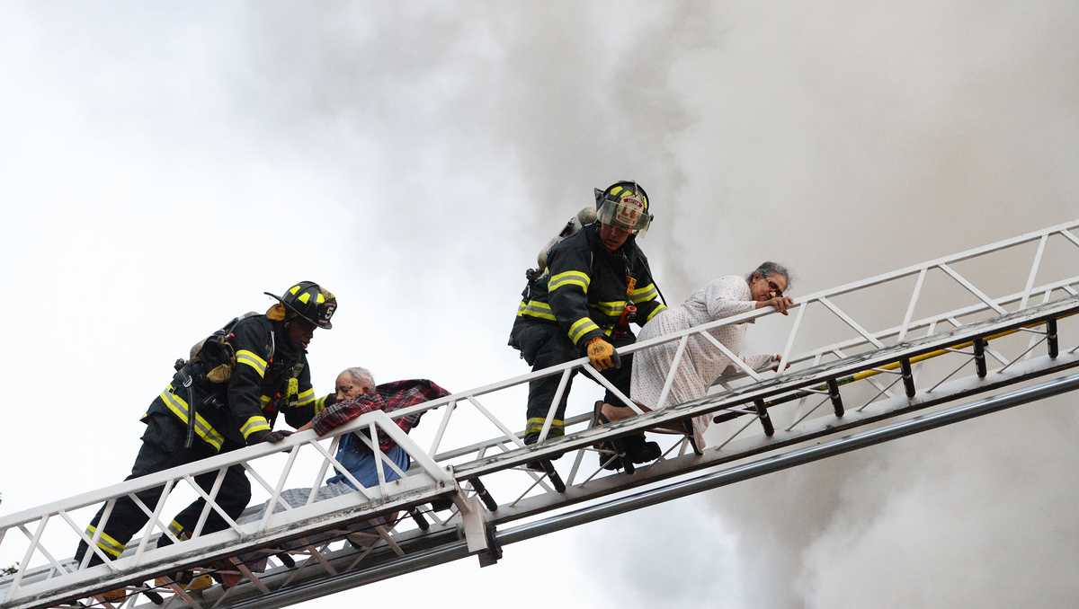 Images: Family rescued by ladder from raging fire