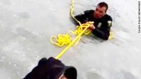 Bodycam video: Police officers fall through ice while rescuing ...