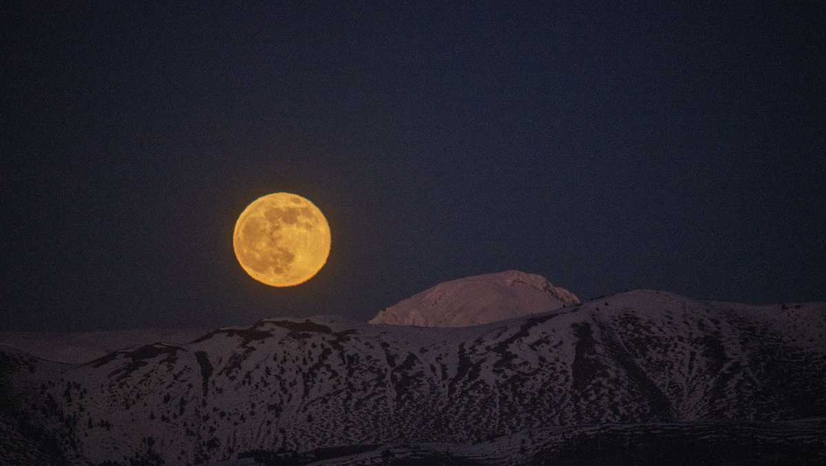 Full 'cold moon' shines bright and eclipses Mars in a rare event