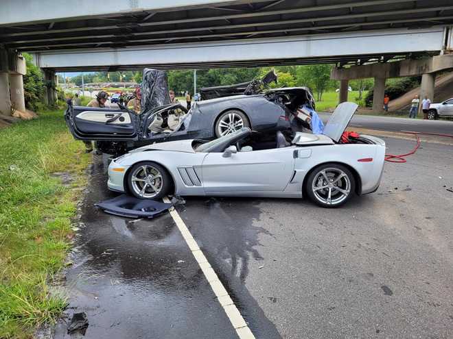 Driver rescued after car falls off bridge and lands on another car ...
