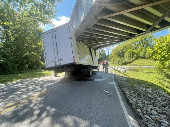 Photos: Box truck gets stuck under bridge in New Albany