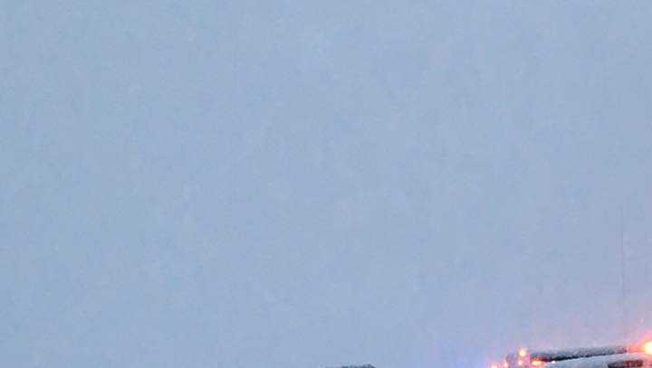 Tour bus slides, overturns on snowy I-91