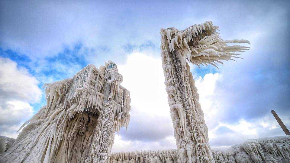Ice forms on lamp posts at pier, resulting in magical, haunting photos