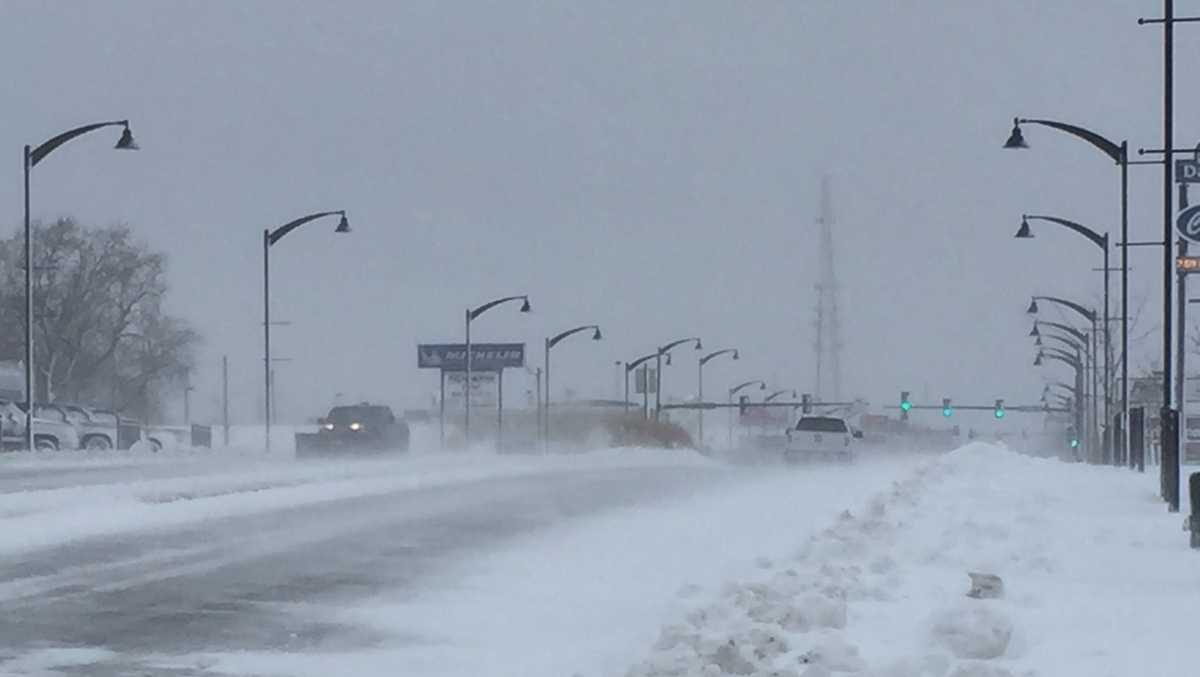 Snow system reducing visibility, blowing snow onto roads