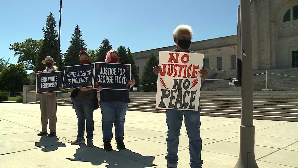 Local protesters peacefully show outrage over police killing