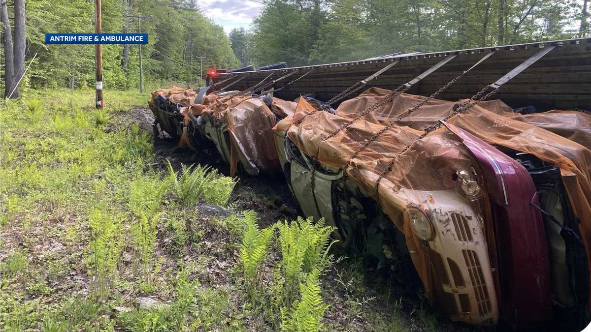 Tractor-trailer carrying crushed up cars rolls over in Antrim, NH