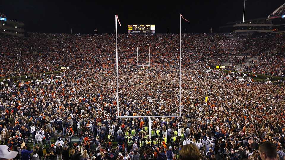 Auburn fans storm field after Iron Bowl win over Alabama, school incurs ...