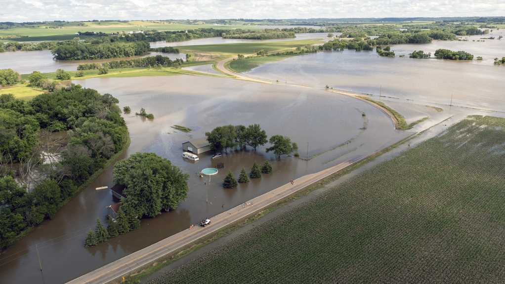 Rail bridge collapses during Midwest flooding as a heat wave persists ...