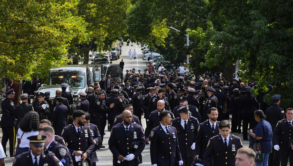 Throngs of police pay tribute to officer killed in New York office shooting