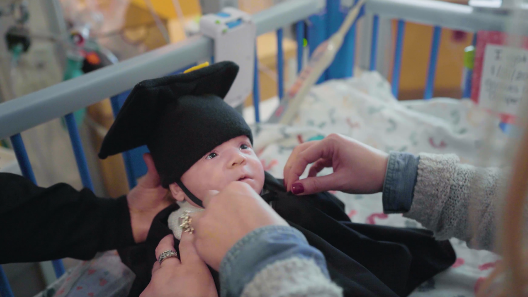 Baby celebrates 'graduation day' from NICU with cap and gown