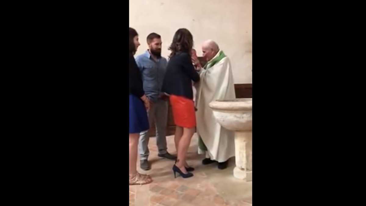 Shocking video shows priest slapping crying baby during baptism