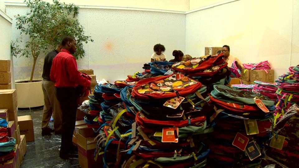 Backpacks stuffed with school supplies destined for city children