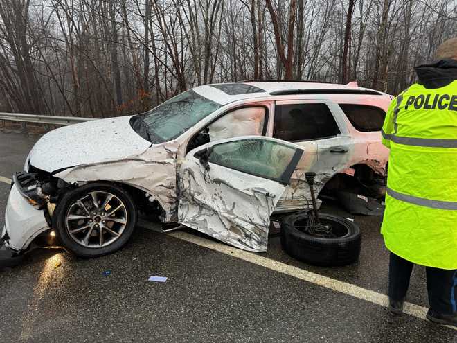 Mass. man charged after crash sends school bus with students into tree