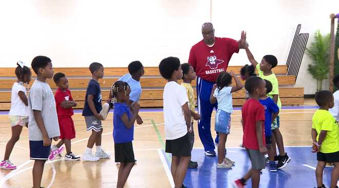 Children learn hoop skills at basketball clinic