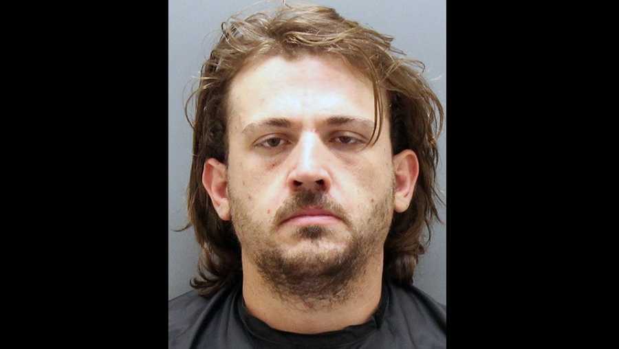 Man attacks woman with ax as she sits in car, smashes out vehicle windows