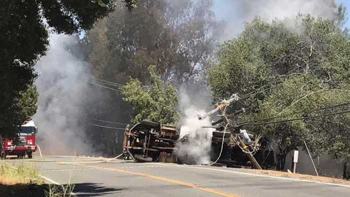 Big rig crashes into power pole, overturns, starts vegetation fire