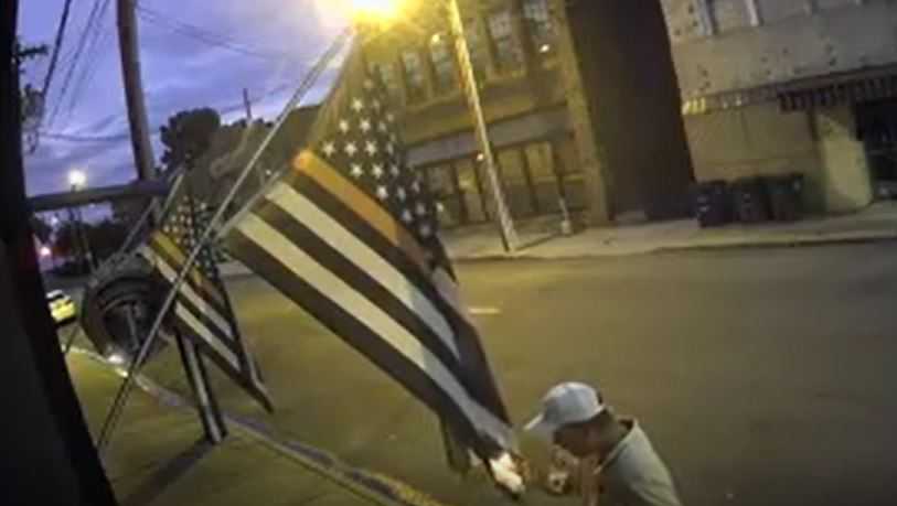 Man caught on camera burning 'blue line' flags outside bar popular ...