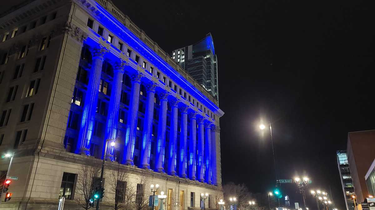 Downtown buildings, landmarks lit up in blue honoring fallen officer
