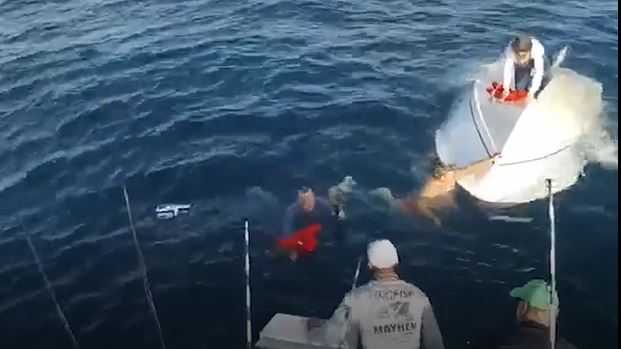 Three rescued from capsized boat