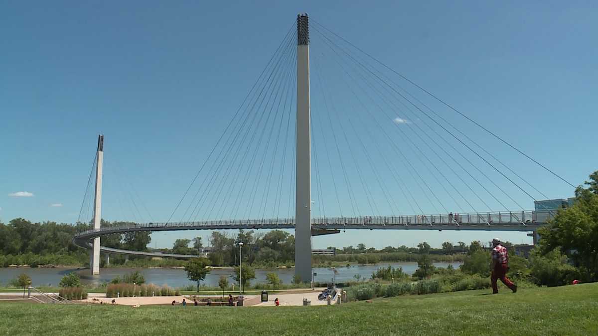 Man recording video captures woman dangling off bridge, pulls her to safety