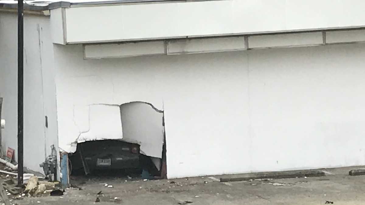 Police: Driver leaves scene after running stolen car through building