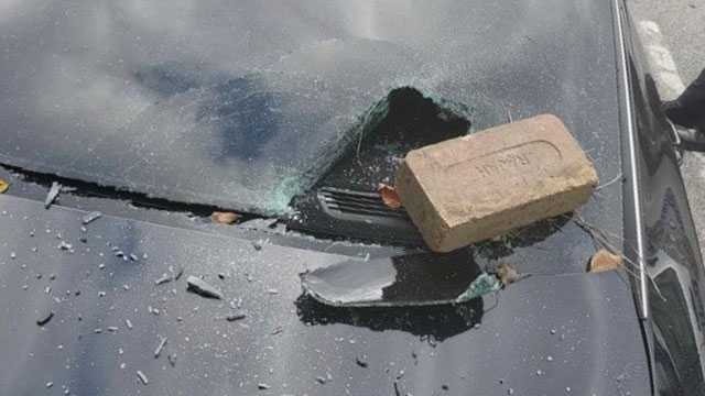 Brick thrown through police car window at station, man arrested