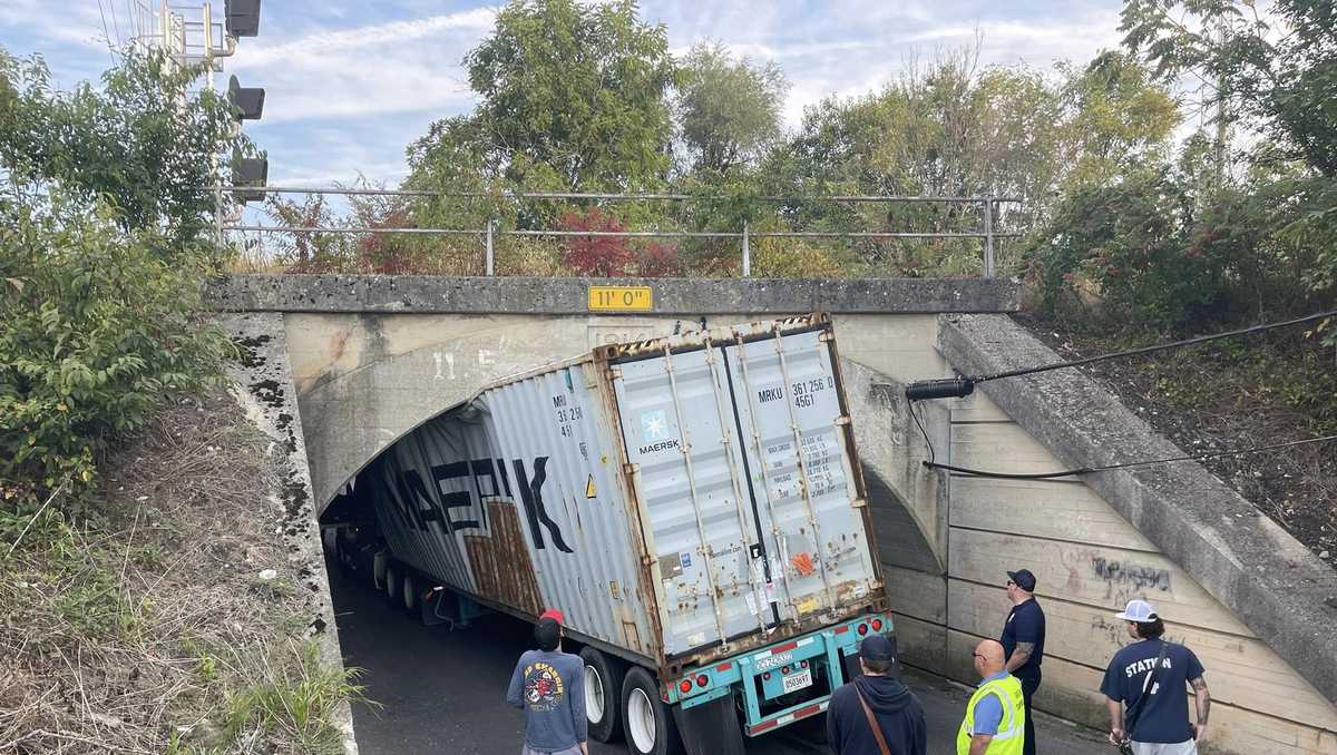 Driver taken to hospital after tractor-trailer gets stuck under ...
