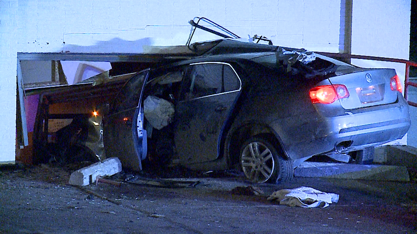 Car hits building, breaks window