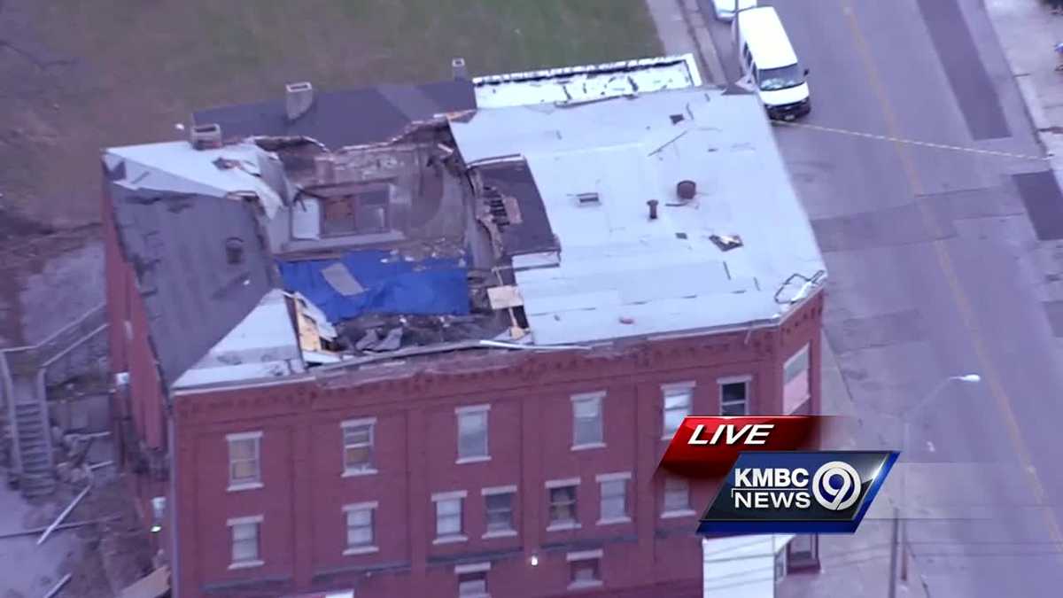 Emergency crews ordered to establish a collapse zone after a partial ...